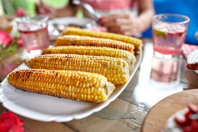 Grilled Corn Cobs on Plate on the Dinner Table, Appetizers Stock Photo ...