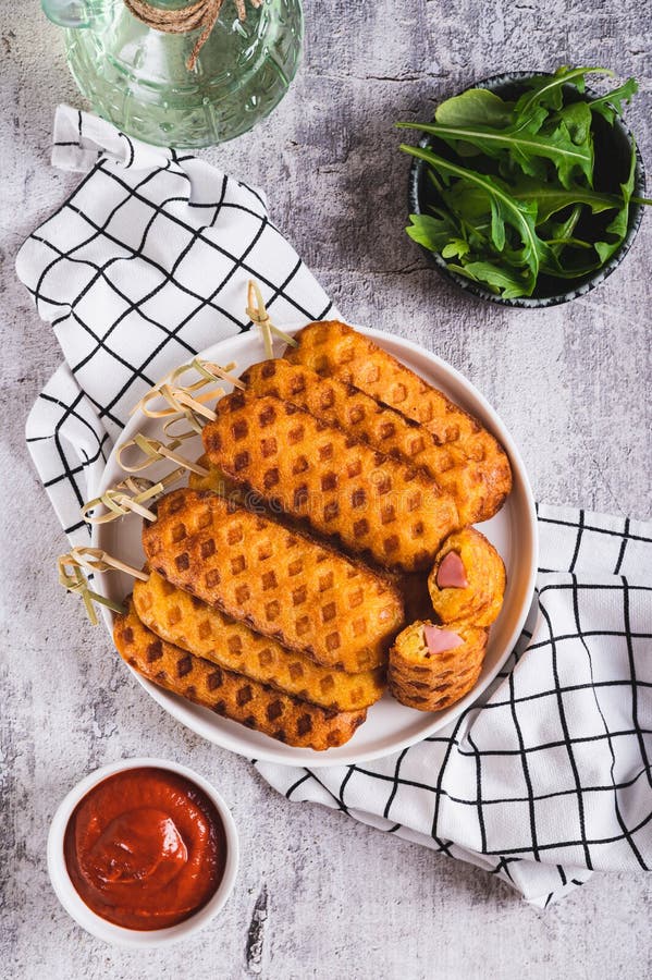 Grilled Corn Dogs with Sausage on a Plate and Ketchup on the Table Top ...