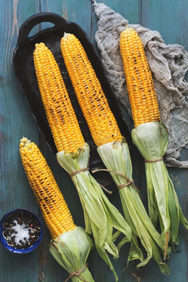 Grilled Corn on a Rustic Background. Cobs of Corn Barbecue Top View ...