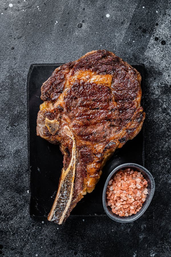 Grilled Cowboy or Rib Eye with Bone Beef Steak. Black Background Stock ...