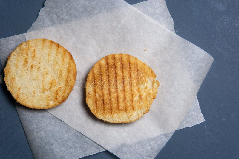 Grilled and Cut in Half Burger Bun on Paper Stock Image - Image of ...