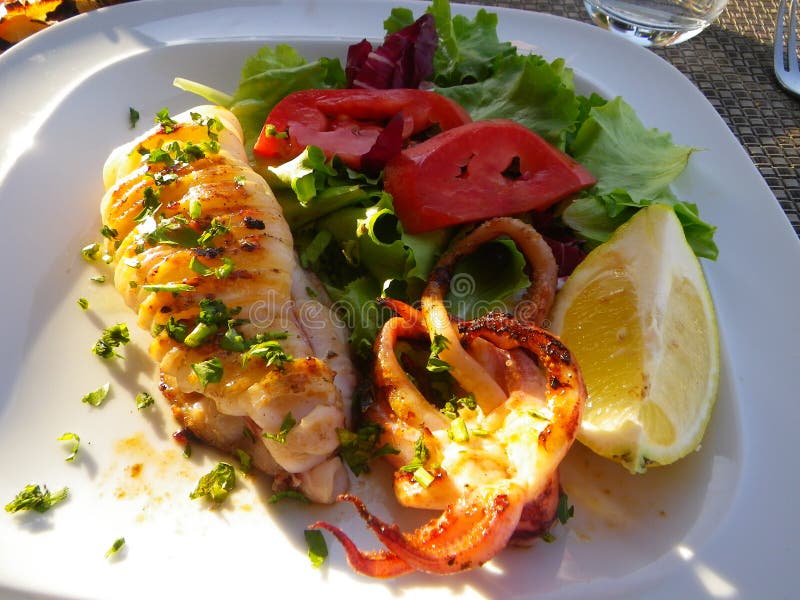 Grilled Cuttlefish with Lemon, Tomato and Spinach and Salad Stock Image ...