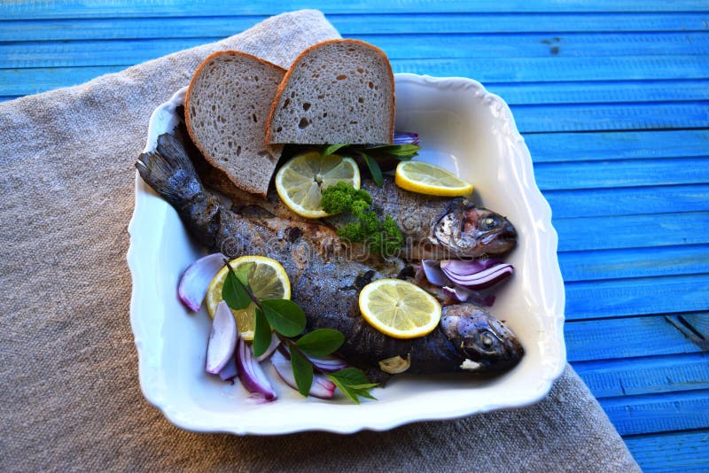 Grilled Fish Served on a Onion and Decorated with Spices and Lemon ...