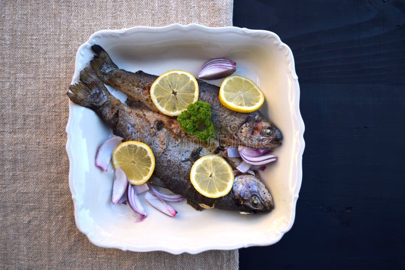 Grilled Fish Served on a Onion and Decorated with Spices and Lemon ...