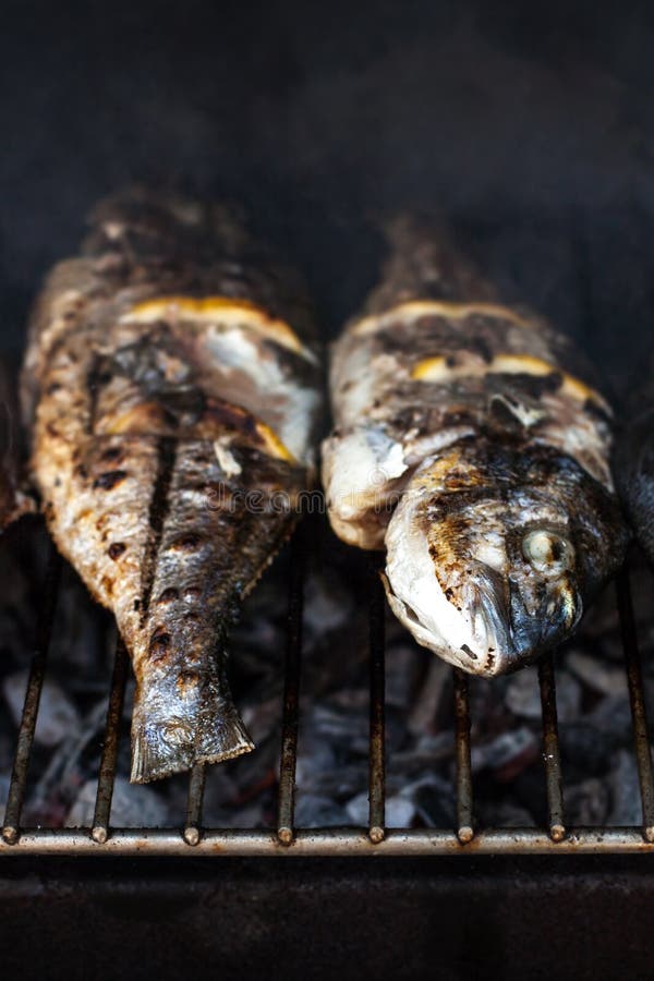 Grilled Fish with Spices on Fire Close Up. Grilling Fish Dorado Stock ...