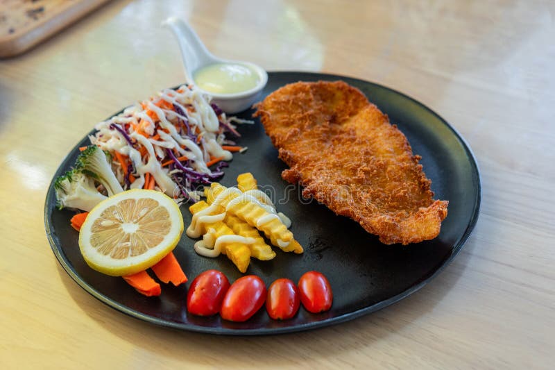 Grilled Fish Steaks with Vegetables Salad on a Plate Stock Photo ...