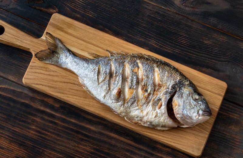 Grilled Fish on the Wooden Board Stock Image - Image of cooking, cooked ...