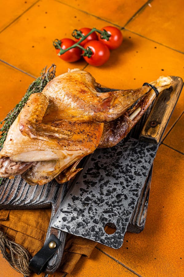 Grilled Guinea Fowl With Herbs And Spices On Butcher Board Cooked Game Bird Orange Background