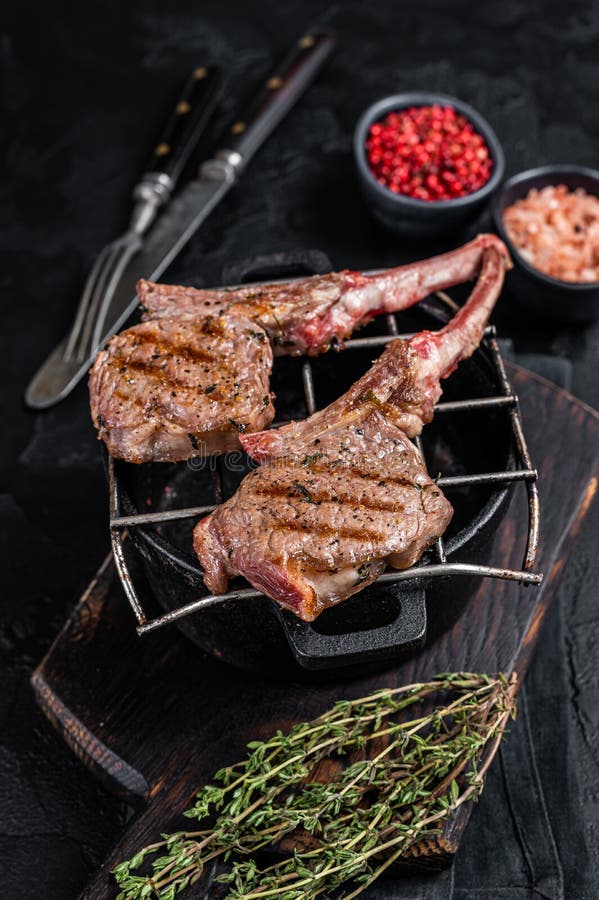 Grilled Lamb Mutton Meat Chops Steaks on a Grill. Black Background ...