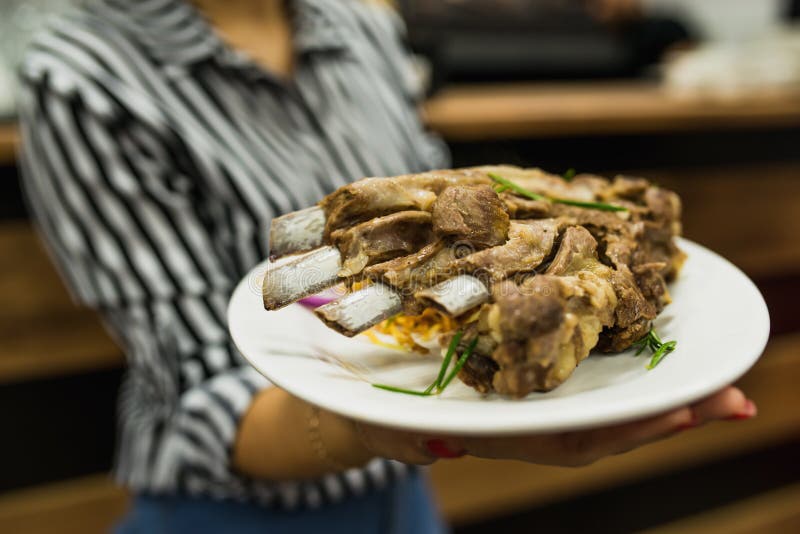 Grilled Lamb Ribs on a White Plate with a Side Dish Stock Photo - Image ...