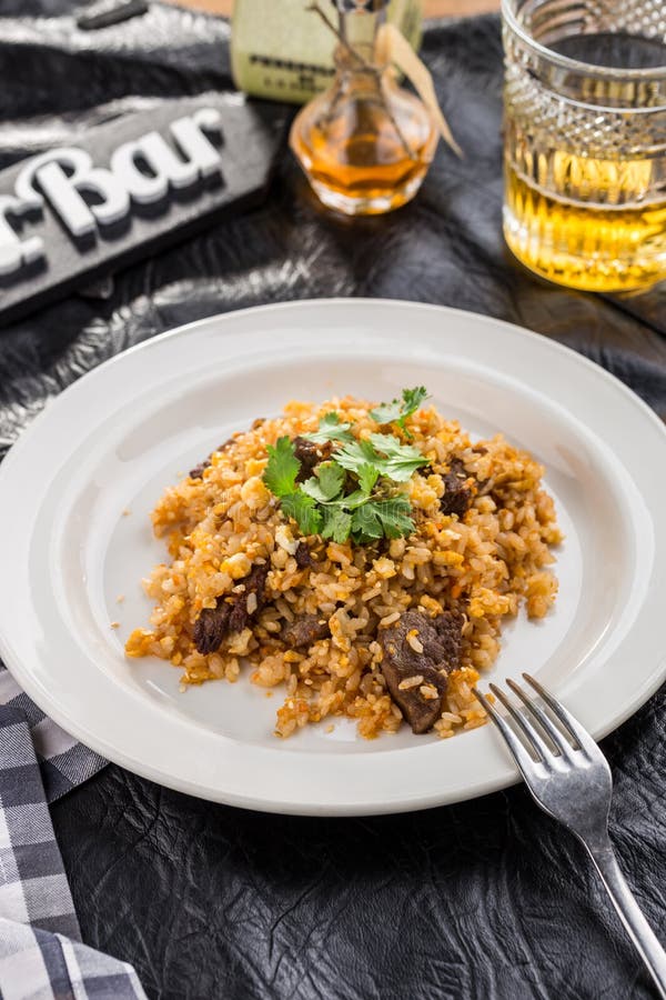 Grilled Lamb with Saffron Rice on Black Table Stock Image - Image of ...