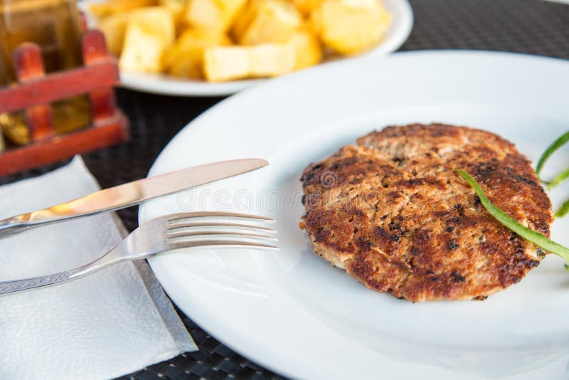 Grilled meat cutlet served stock image. Image of green - 39095797
