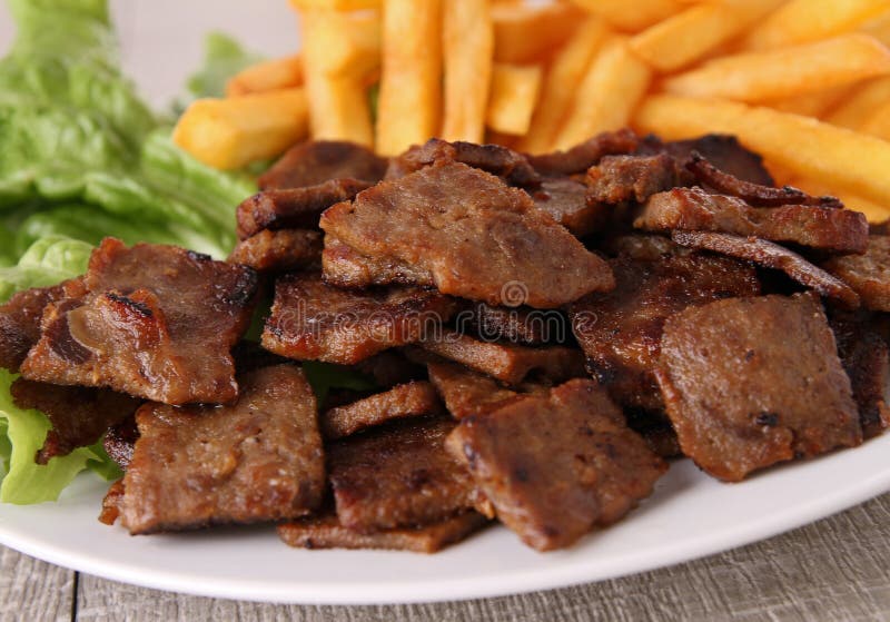 Grilled meat and fries stock image. Image of cuisine - 23598159