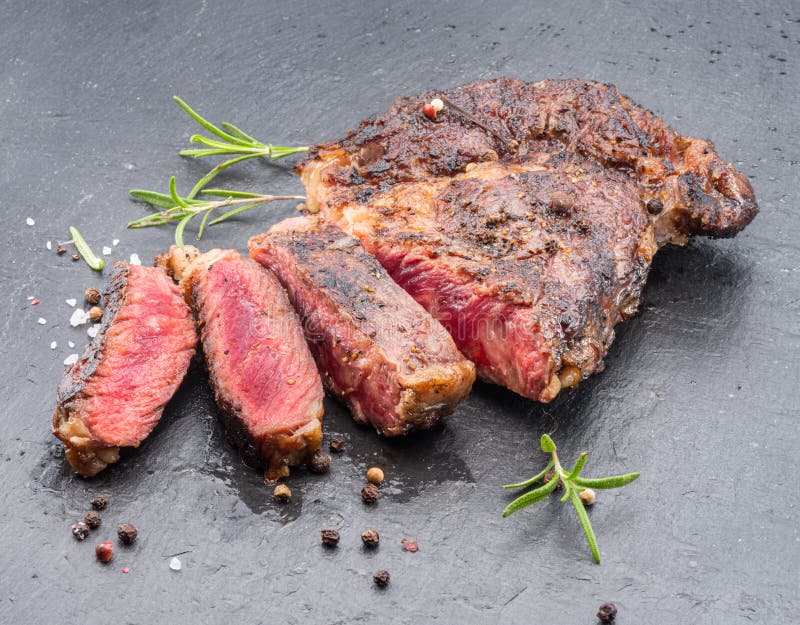 Grilled Medium Rare Ribeye Steak on Gray Stone Plate Stock Image ...