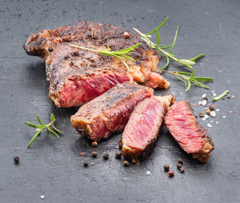 Grilled Medium Rare Ribeye Steak on Gray Stone Plate Stock Photo ...