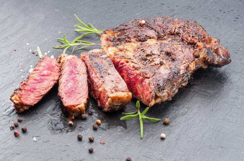 Grilled Medium Rare Ribeye Steak on Gray Stone Plate Stock Photo ...