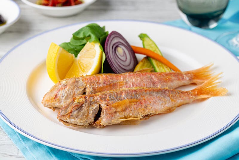 Grilled Mullet Fish with Arugula and Mini Vegetables on a White ...