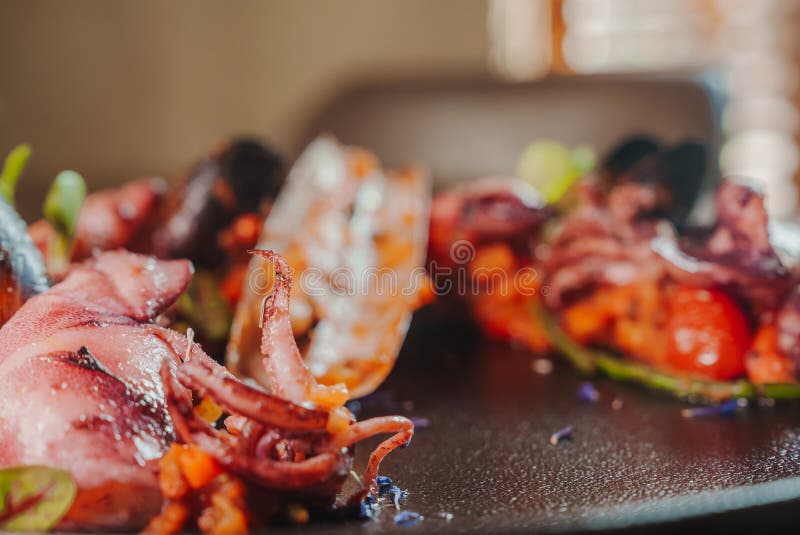 Grilled Octopus with Calmars, Salad and Lemon on Plate. Stock Photo ...