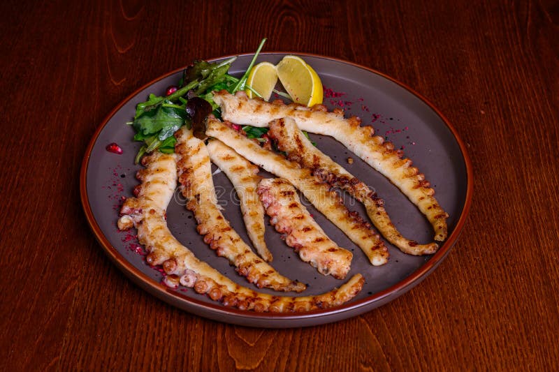 Grilled Octopus with Lemon on Plate. Stock Photo - Image of gourmet ...