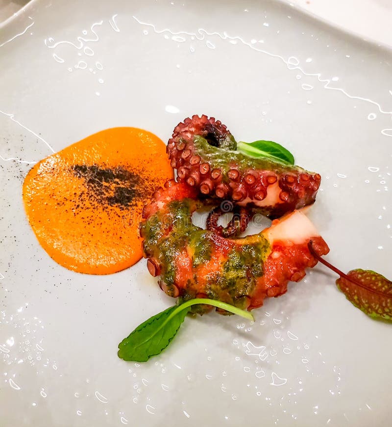 Grilled Octopus Tentacles with Orange Sauce and Arugula, Top View ...