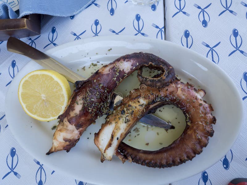 Grilled Octopus Tentacles with a Slice of Lemon Stock Photo - Image of ...