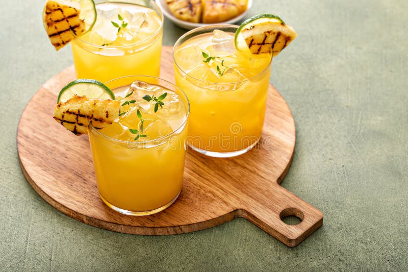 Grilled Pineapple Margarita Garnished with Lime Wedges Stock Photo ...