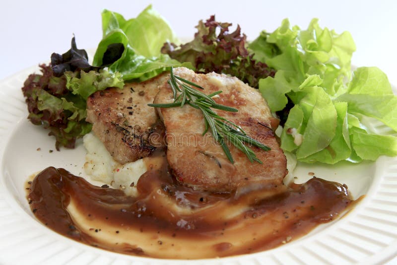 Pork Cutlet with French Fries, Green Salad and Quail Egg Stock Photo ...