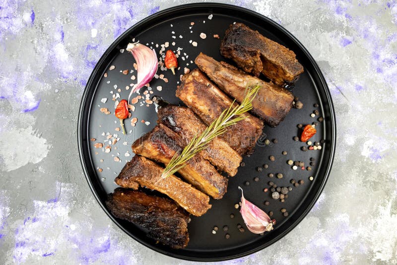 Grilled Pork Ribs with Aromatic Spices on a Black Plate, Top View Stock ...