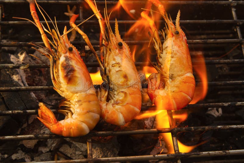 Grilled prawns on flaming stock image. Image of cooking - 38948487