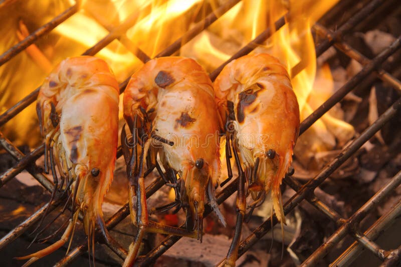 Grilled prawns on flaming stock image. Image of restaurant - 38667859