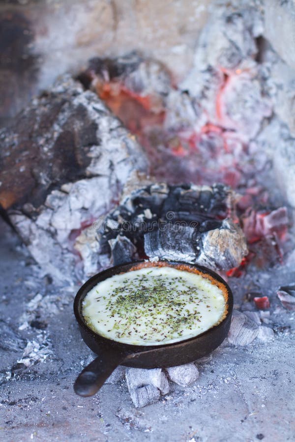 Grilled Provolone in a Cast Iron Skillet Over the Coals in the Barbecue ...