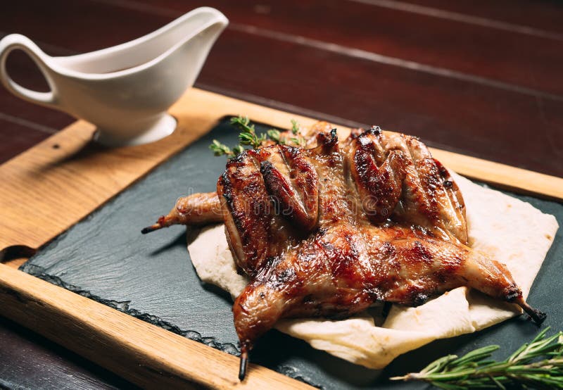 Grilled Quails on Wooden Plate on the Table Stock Photo - Image of ...