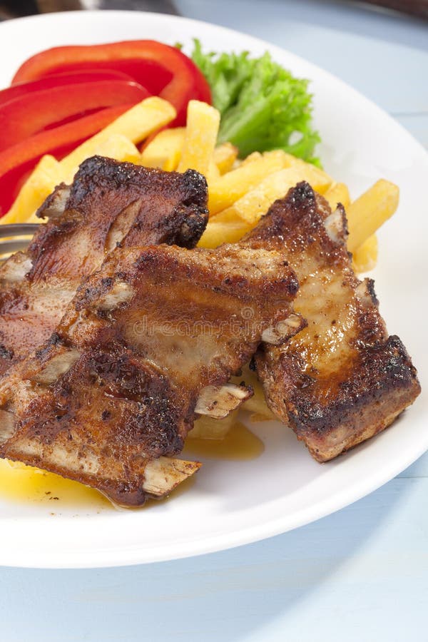 Grilled ribs on plate stock photo. Image of ribs, restaurant - 190125604