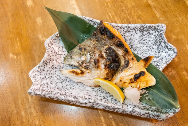 Grilled Salmon Fish Head with Lemon at Japanese Restaurant Stock Image ...