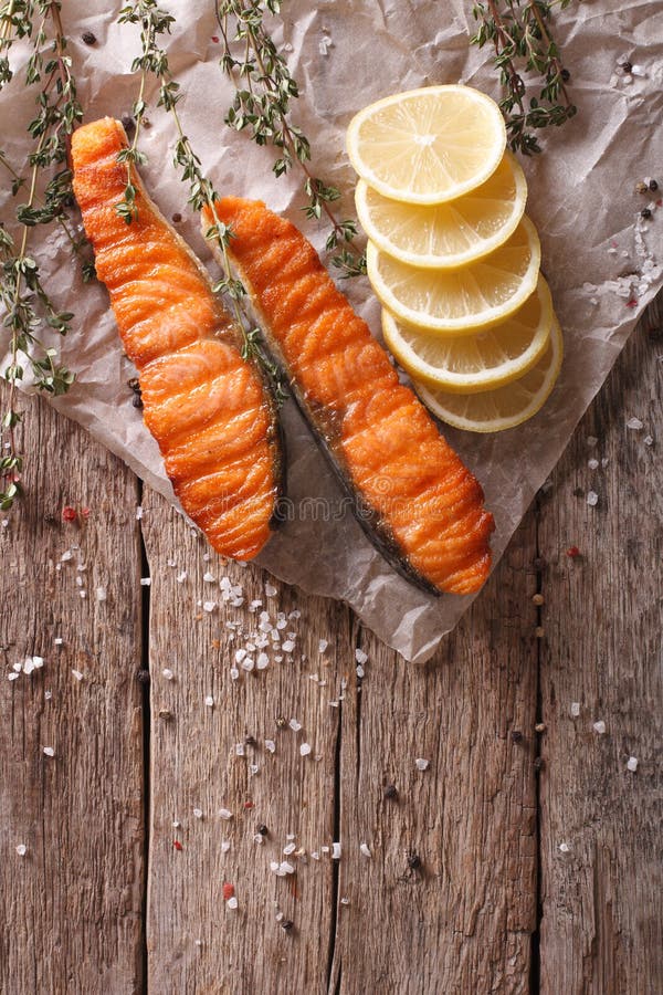 Grilled Salmon with Lemon and Thyme on a Paper. Vertical Top Vie Stock ...