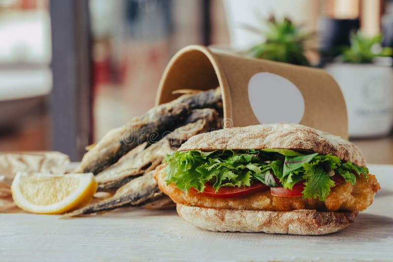 Grilled Sea Fish with Lemon Wedges Street Food in Box on Wooden ... Grilled Sea Fish with Lemon Wedges Street Food in Box on Wooden ...