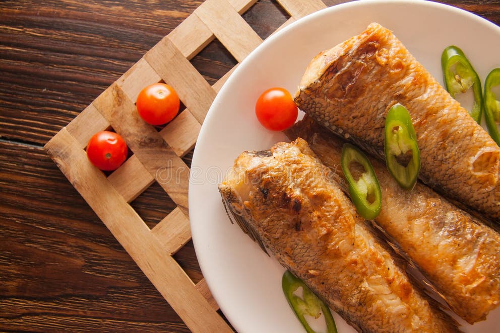 Grilled shad with tomato stock photo. Image of onion - 77023770