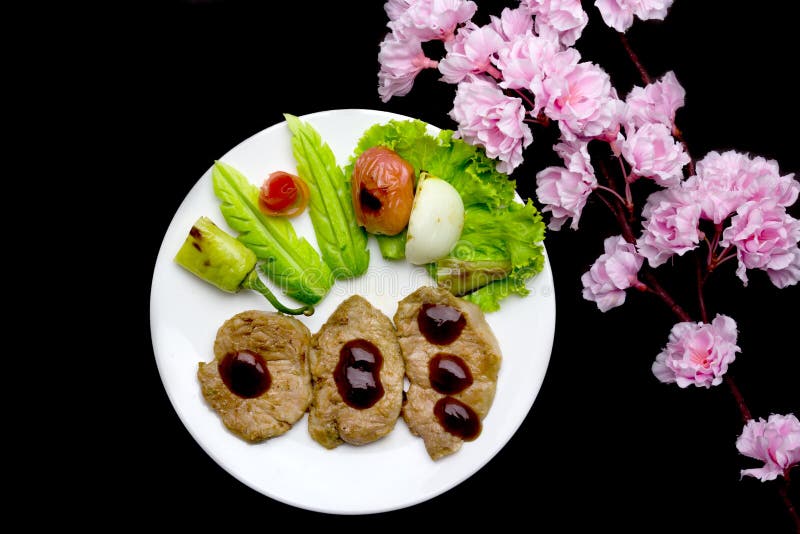 Grilled Steak Meat with Pink Flower Isolated on Black Background Stock ...