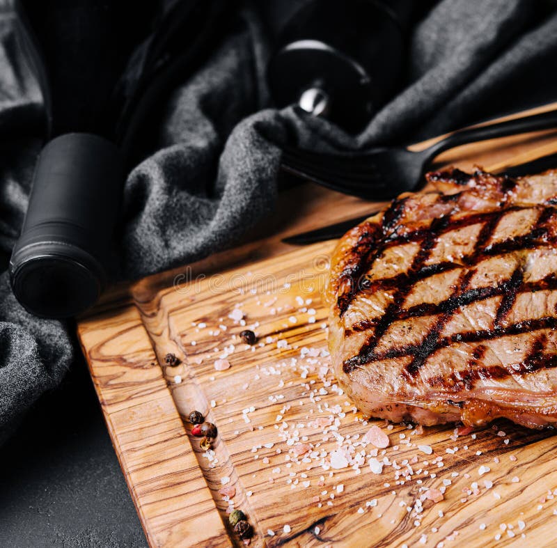 Grilled Striploin Sliced Steak on Cutting Board Over Stone Table Stock ...