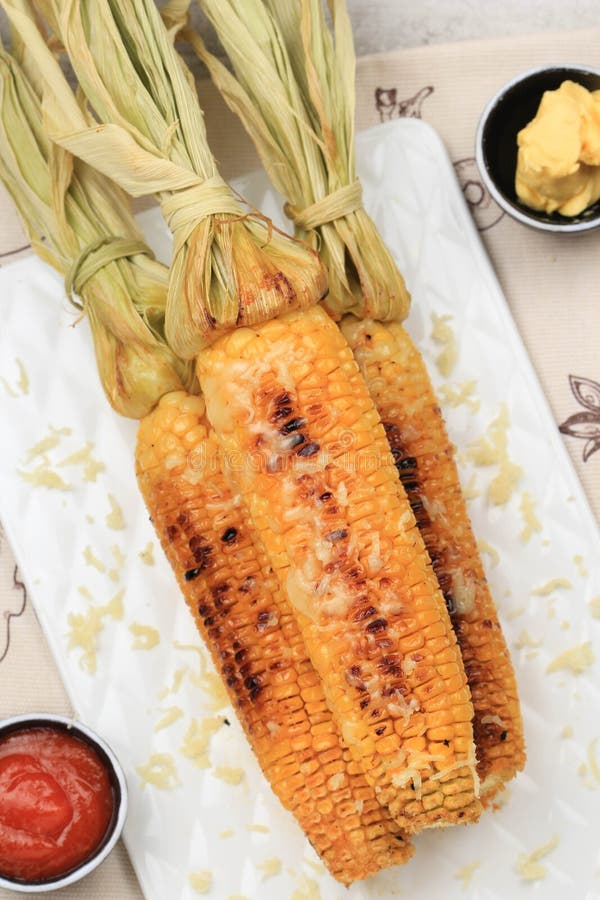 Grilled Corn with Butter and Shredded Mozarella. Served on White Plate ...