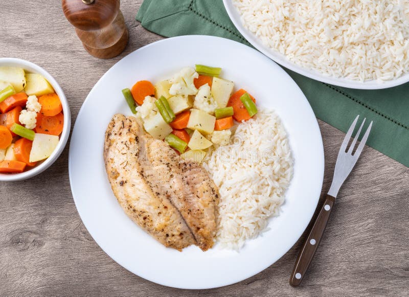 Grilled Tilapia or Saint Peter with Rice and Vegetables Stock Image ...