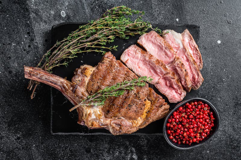 Grilled Tomahawk Beef Steak, Rib Eye with Thyme. Black Background Stock ...