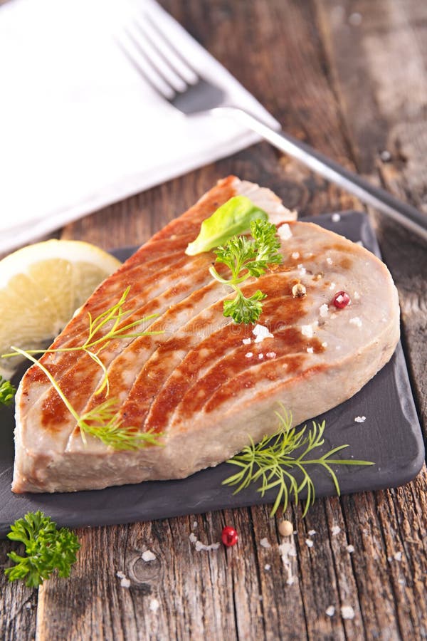 Grilled tuna fish fillet stock photo. Image of herb - 181744560