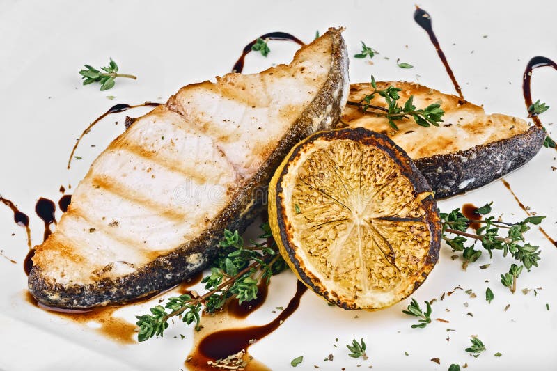 Grilled White Fish Steak with Lemon Slice and Herbs Stock Photo - Image ...