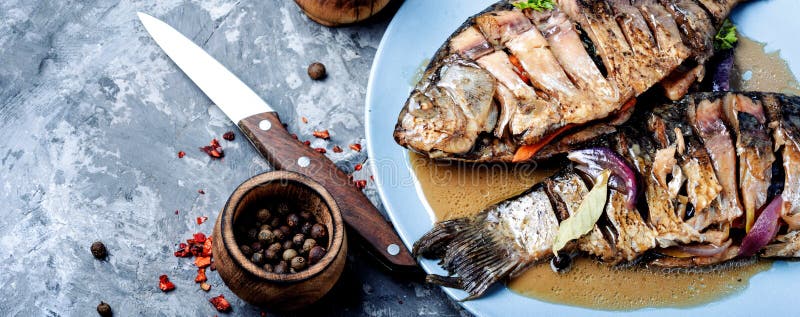 Tasty baked fish on plate stock photo. Image of fried - 142479778