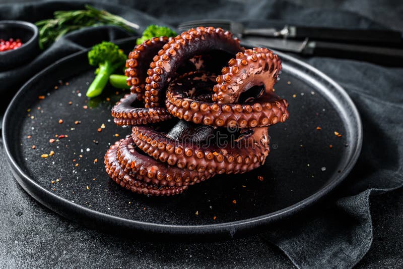 Grilled Whole Octopus with Broccoli on a Plate. Black Background Stock ...