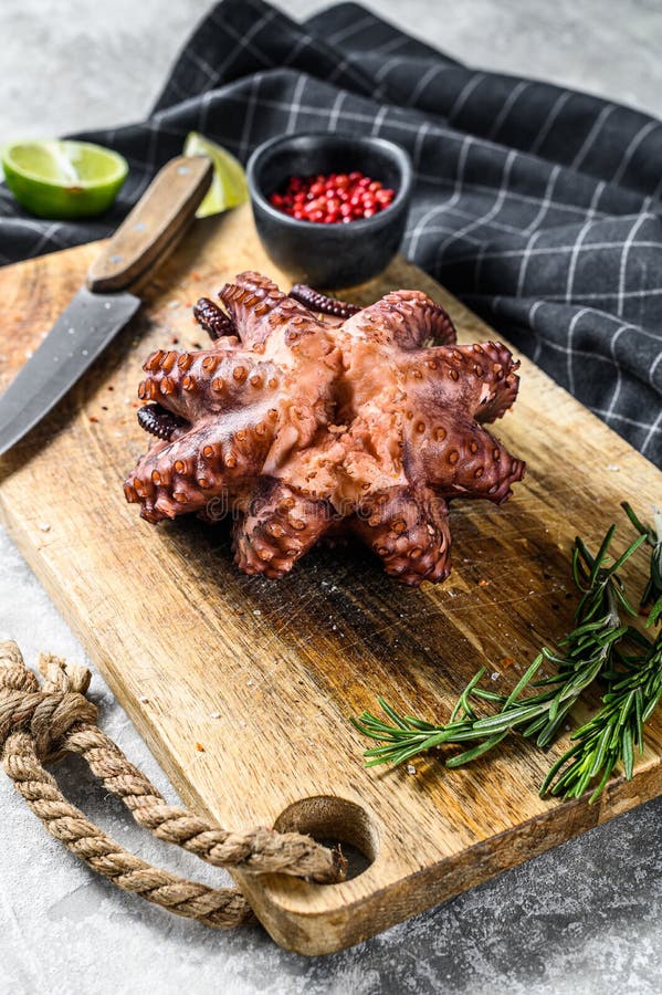 Grilled Whole Octopus on a Cutting Board. Gray Background Stock Photo ...