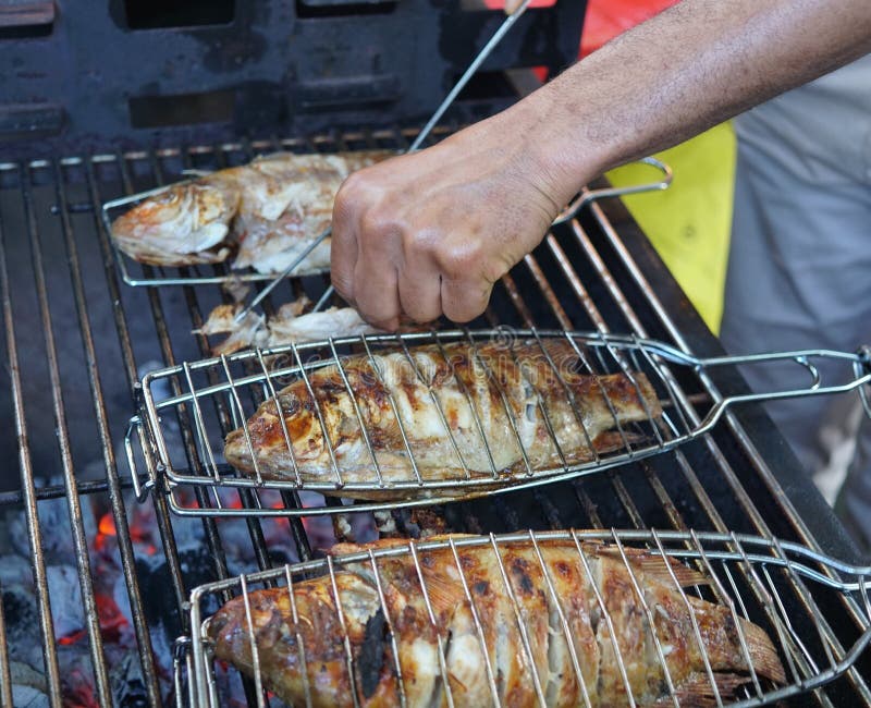 Grilling fish on barbecue stock photo. Image of closeup - 117154170