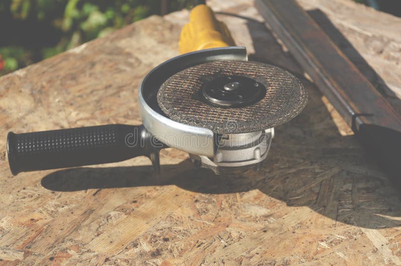 A Grinder with a Metal Disc is Lying on the Table Stock Photo - Image ...