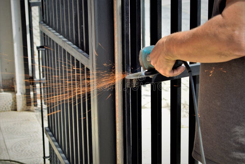 Grinder Releasing a Spark of Fire at the Gate Stock Photo - Image of ...